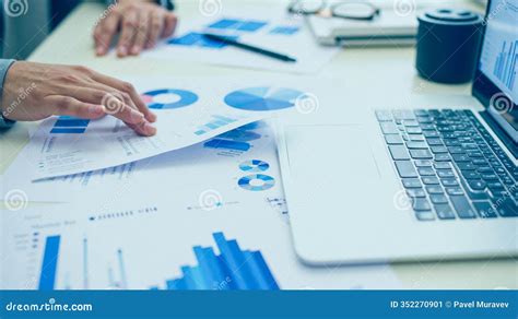 Business Meeting With Charts And Graphs Hands Holding Documents