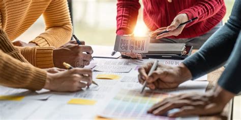 Group Of Ux Developer And Ui Designer Brainstorming About App Interface