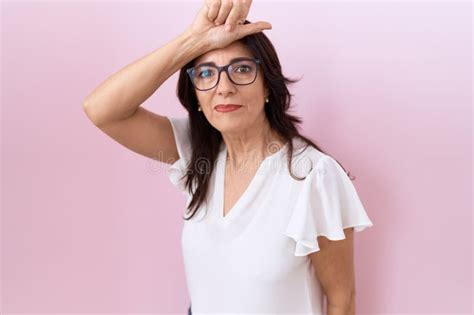 Middle Age Hispanic Woman Wearing Casual White T Shirt And Glasses