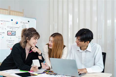 Creative Team Collaboration On Ux Ui Design Project In Modern Office Setting With Whiteboard And
