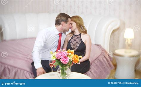 Couple Drinking Wine On The Bed An Elegant Couple A Man In A Suit And