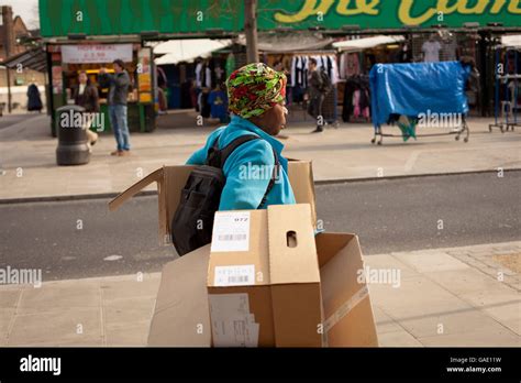 Woman Carrying Boxes Through London Streets Stock Photo Alamy