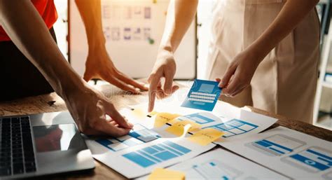 Ux Developer And Ui Designer Brainstorming About Mobile App Interface Wireframe Design With