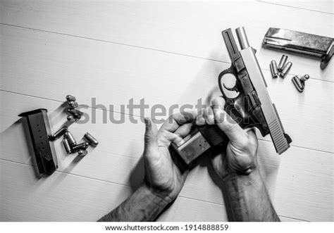 Man Disassembling Gun Above White Table Stock Photo 1914888859 Shutterstock