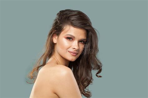 Glorious Young Woman With Long Curly Hair With Bare Shoulders Stock