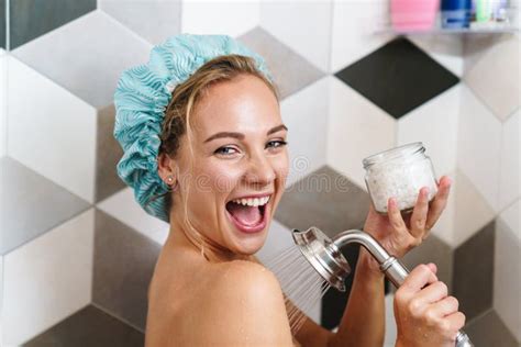Image Of Young Woman Smiling While Taking Shower In Bathroom At Home