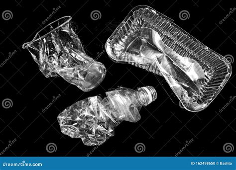 Various Disposable Crumpled Plastic Garbage Isolated On A Black Background Concept Of Recycling