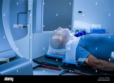 Patient In Mask For Whole Brain Radiotherapy Treatment Or Total Brain