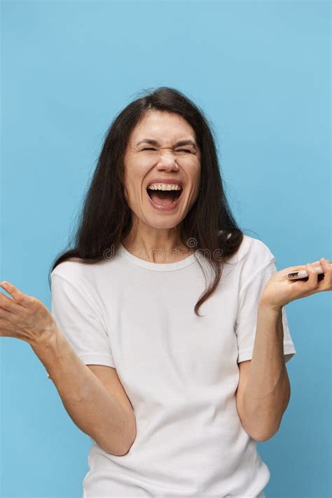 A Happy Joyful Woman Stands With A Phone In Her Hands Spreading Her