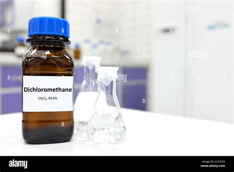 Selective Focus Of Dichloromethane Liquid Chemical Compound In Dark Glass Bottle Inside A
