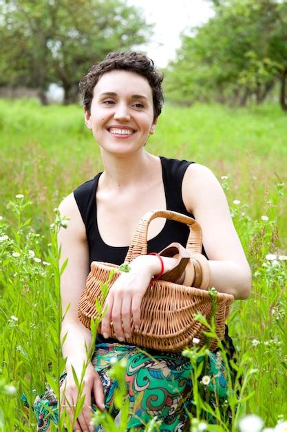 Premium Photo Woman With Basket In The Garden