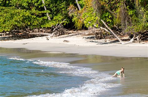 코스타리카 태평양 연안의 마누엘 안토니오 국립공원에 있는 마누엘 안토니오 해변의 야생의 길들여지지 않은 해안에서 노는 유아
